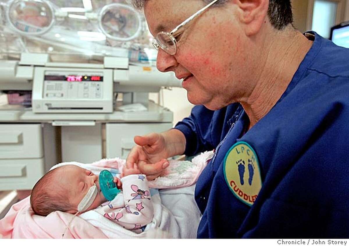 Cuddlers lend their hearts and hands to preemies / Volunteers stand in ...