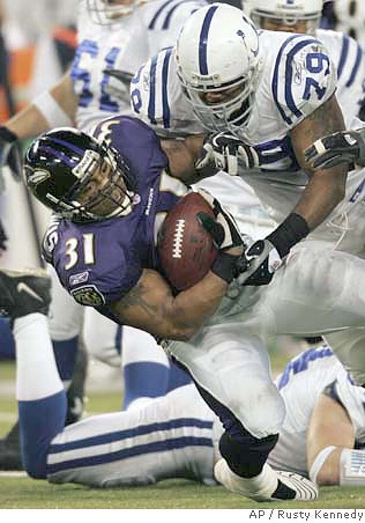 Colts carry Manning for change / Vinatieri, defense do the job in Baltimore