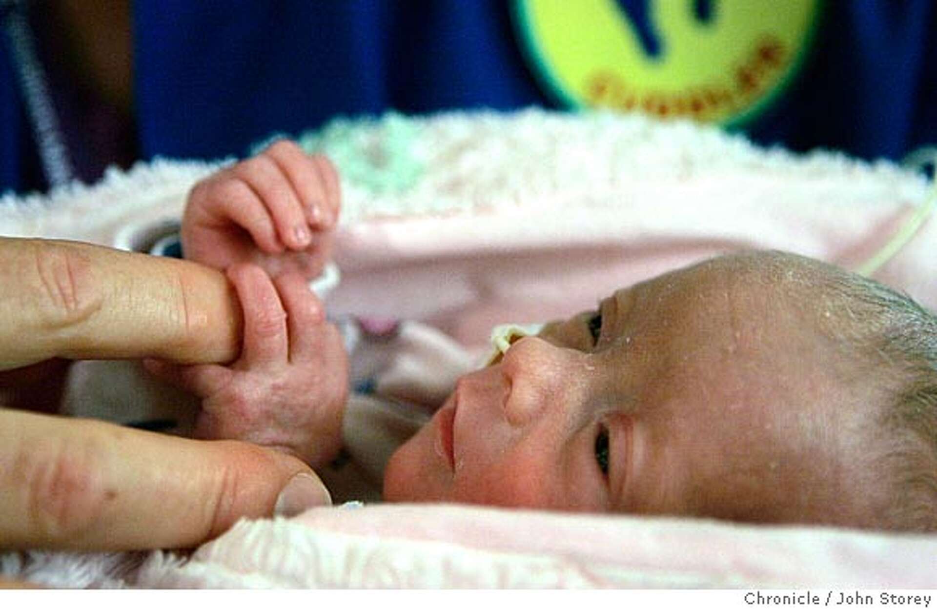 Cuddlers lend their hearts and hands to preemies / Volunteers stand in ...