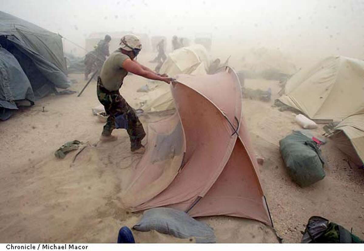 Fighting the sandstorm... / WIND PREVAILS: Advance grinds to halt in desert