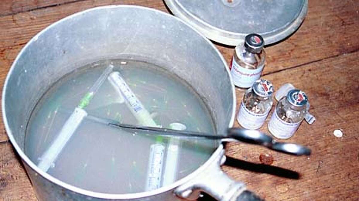 New AIDS suspect / Researchers say reuse of needles as much to blame as ...