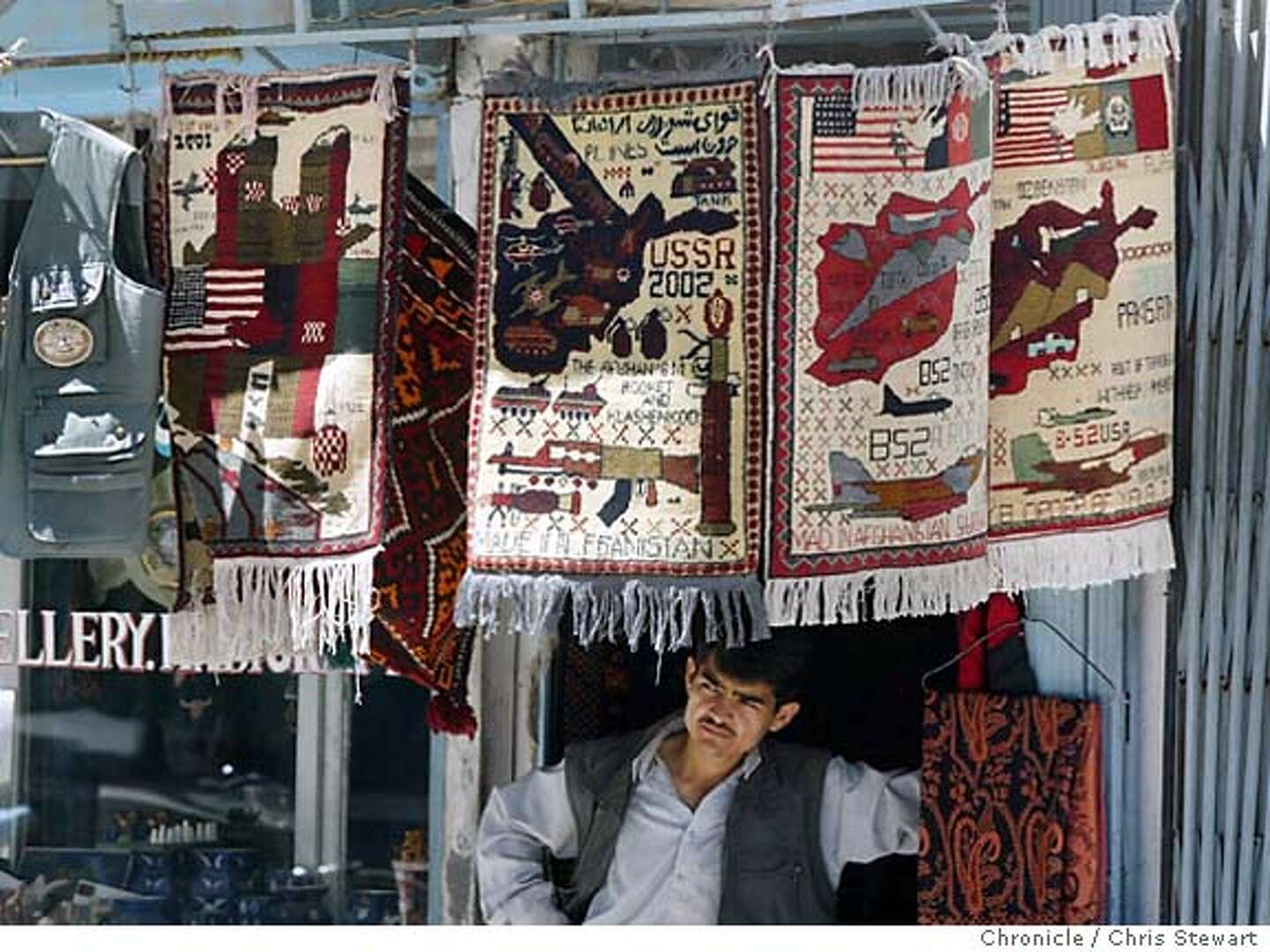 War's warp and weft / Afghan weavers incorporate battle scenes, World ...