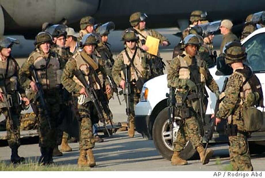 Aristide loyalists vow fight to death / Barricades erected as rebels ...