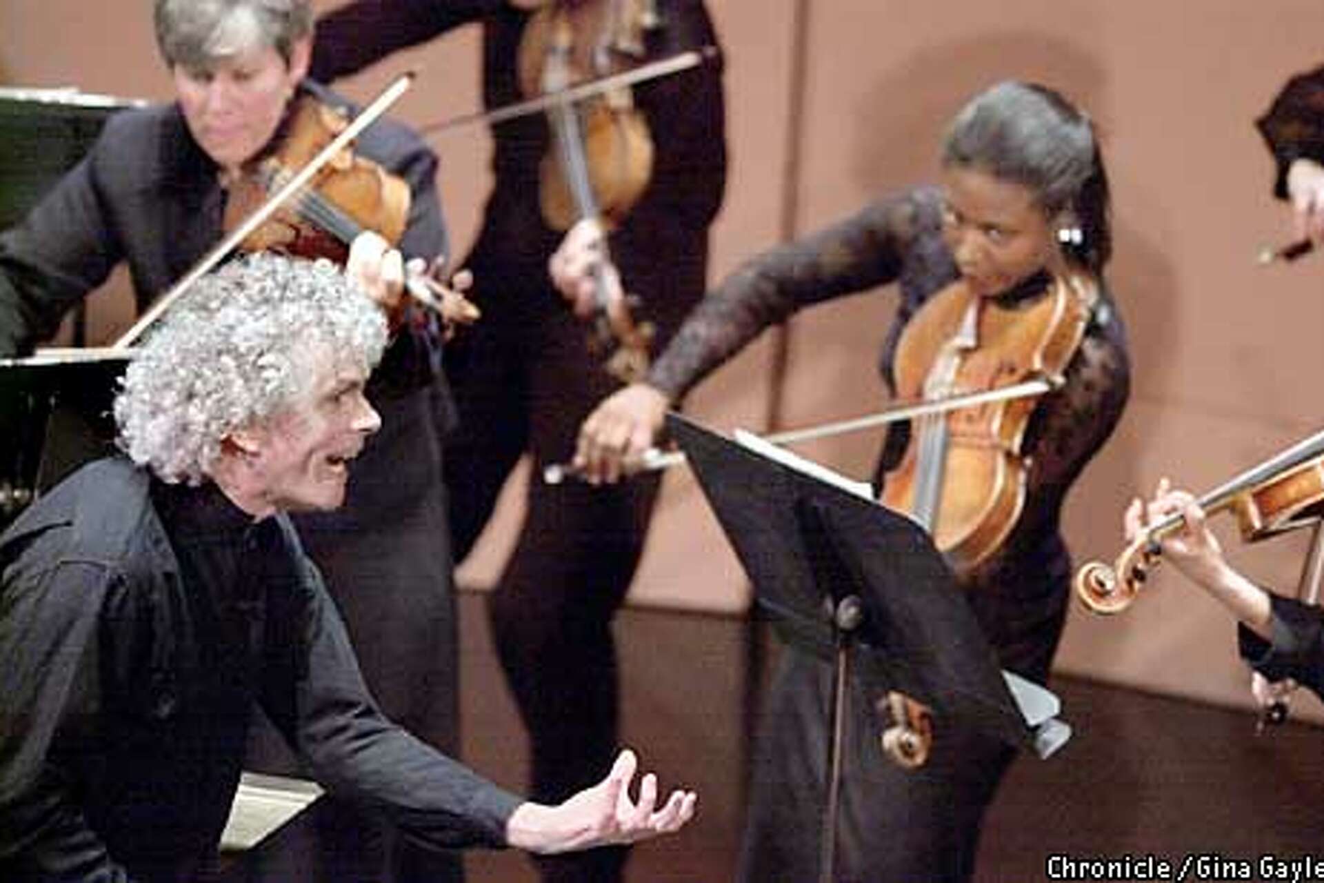 Rattle's stunning return / Star conductor leads New Century