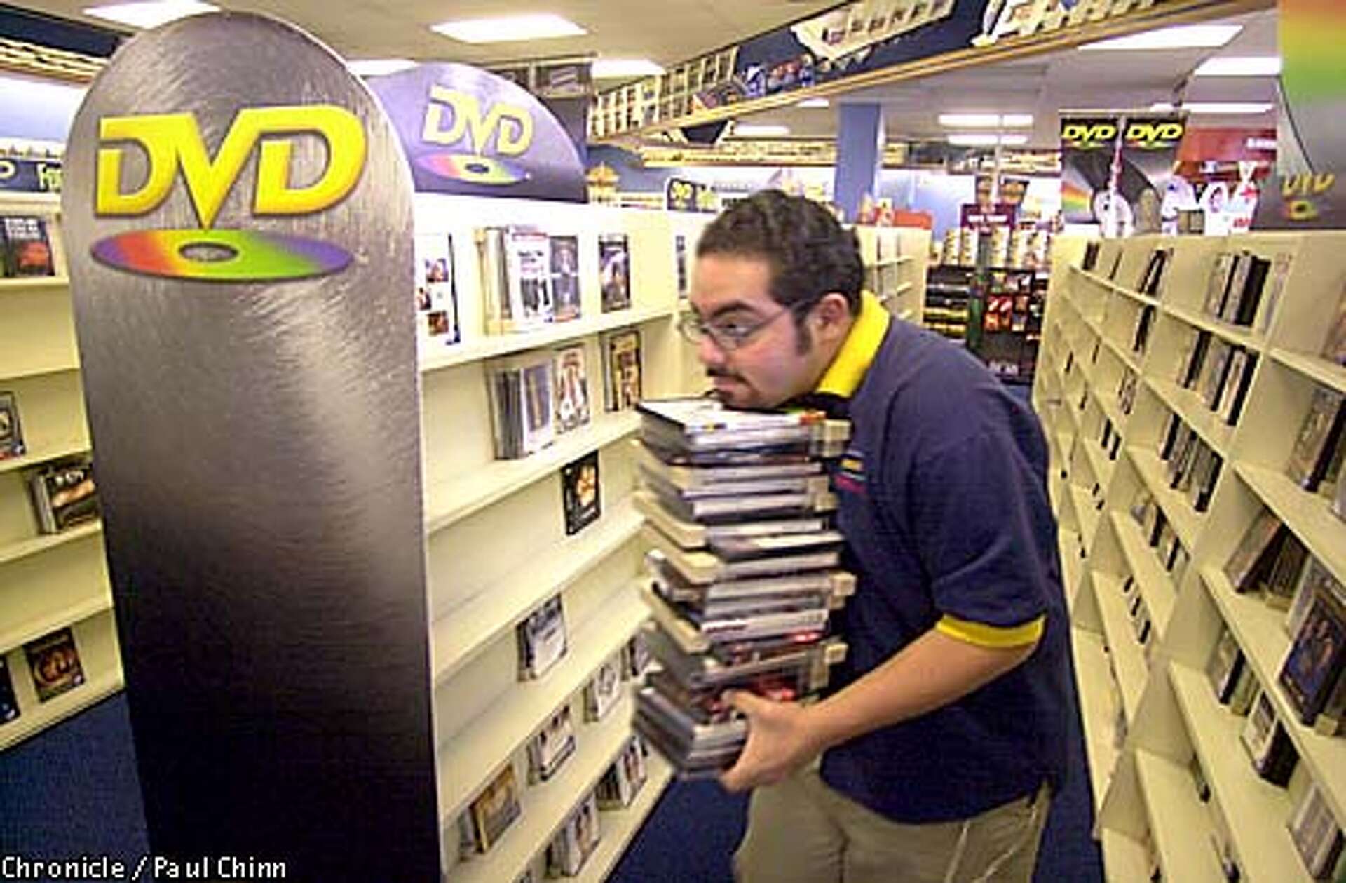 Making room for DVDs / Video stores are rearranging their displays and ...