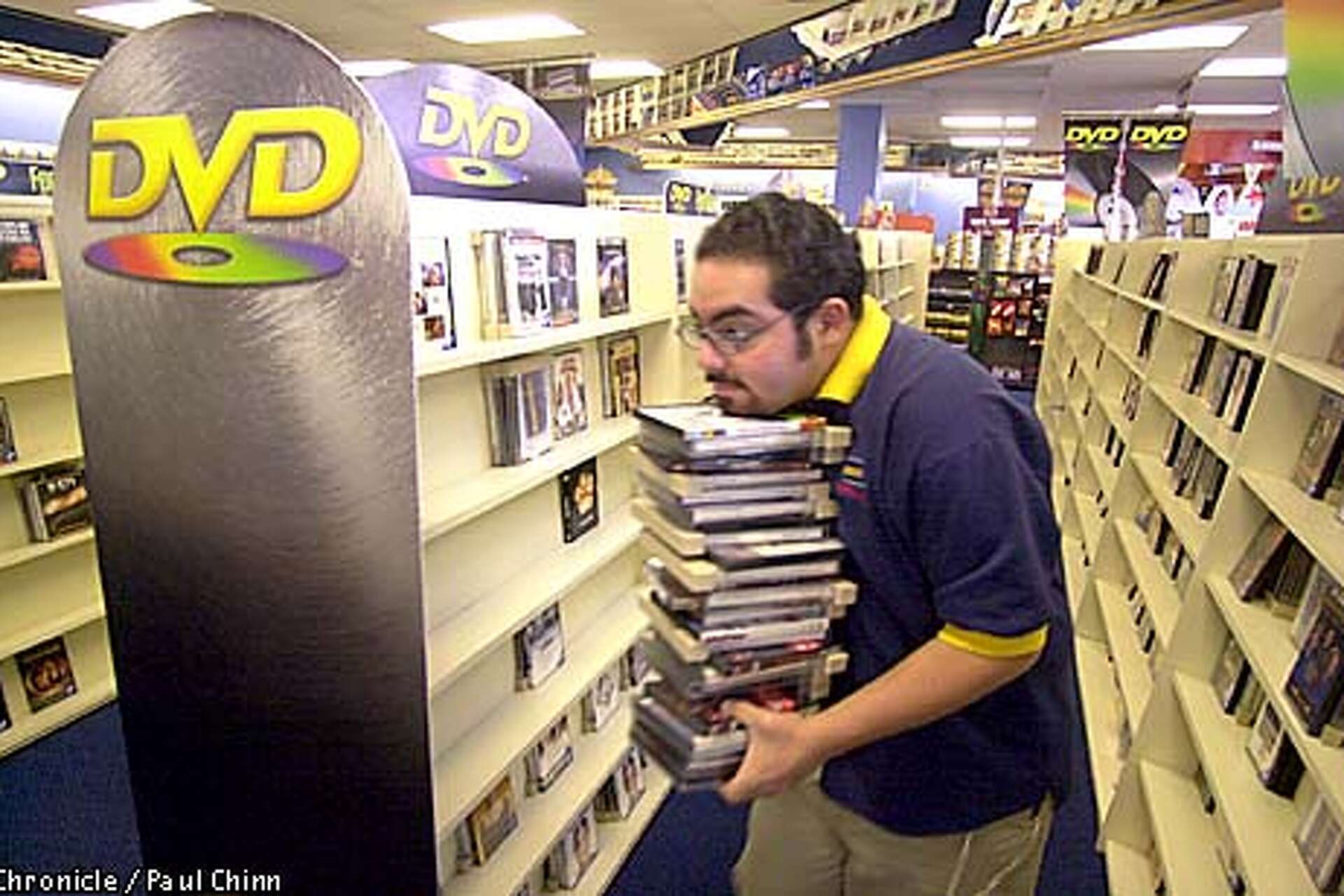 Making room for DVDs / Video stores are rearranging their displays and ...