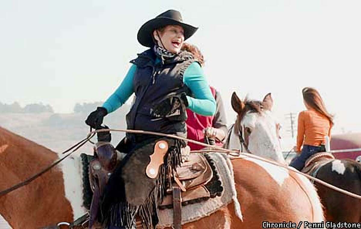 Urban cowgirl / Herding cattle up the street to the Grand National Rodeo