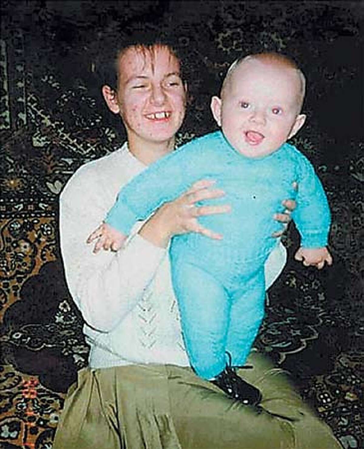 Fugitive's son found slain on trash heap / Message on family photo ...