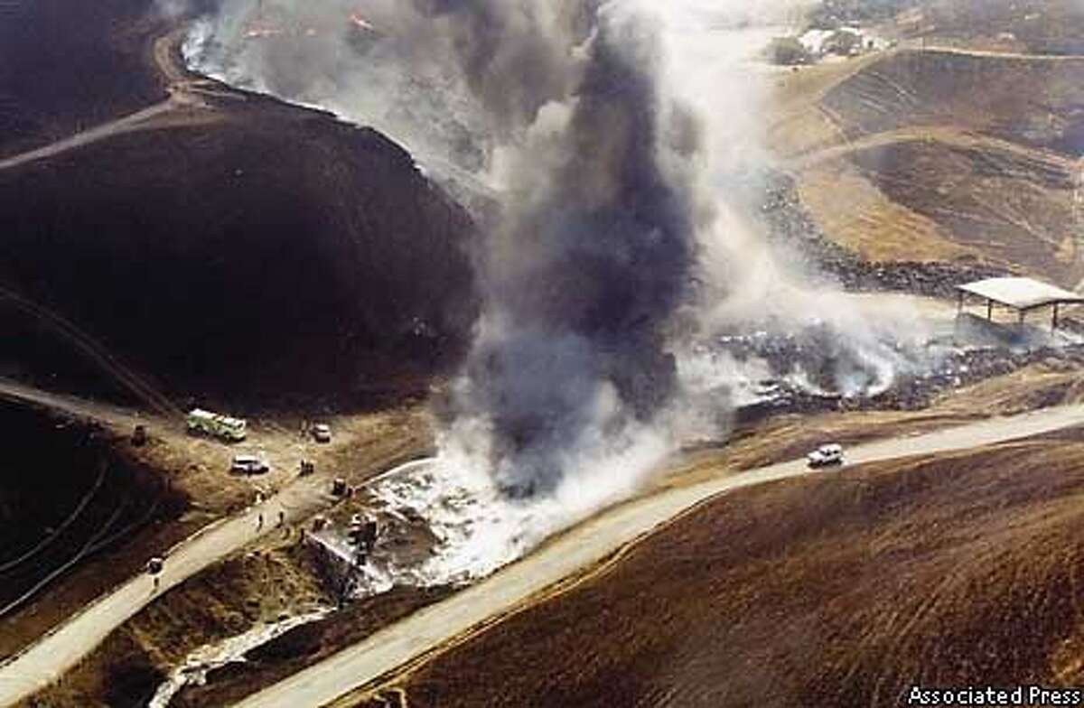 Tire Fire's New Problem -- Gallons of Burning Oil / Acrid smoke chokes ...