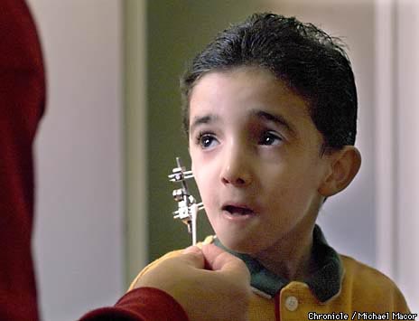 HEALING MUSTAFA / Boy from Iraq gets special medical help on the Peninsula