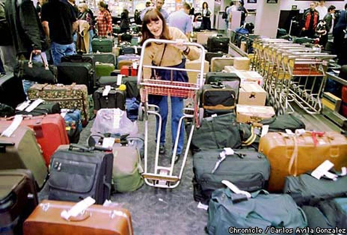 Welcome to Bag Mountain / Piles of luggage confront people at fog-hit SFO