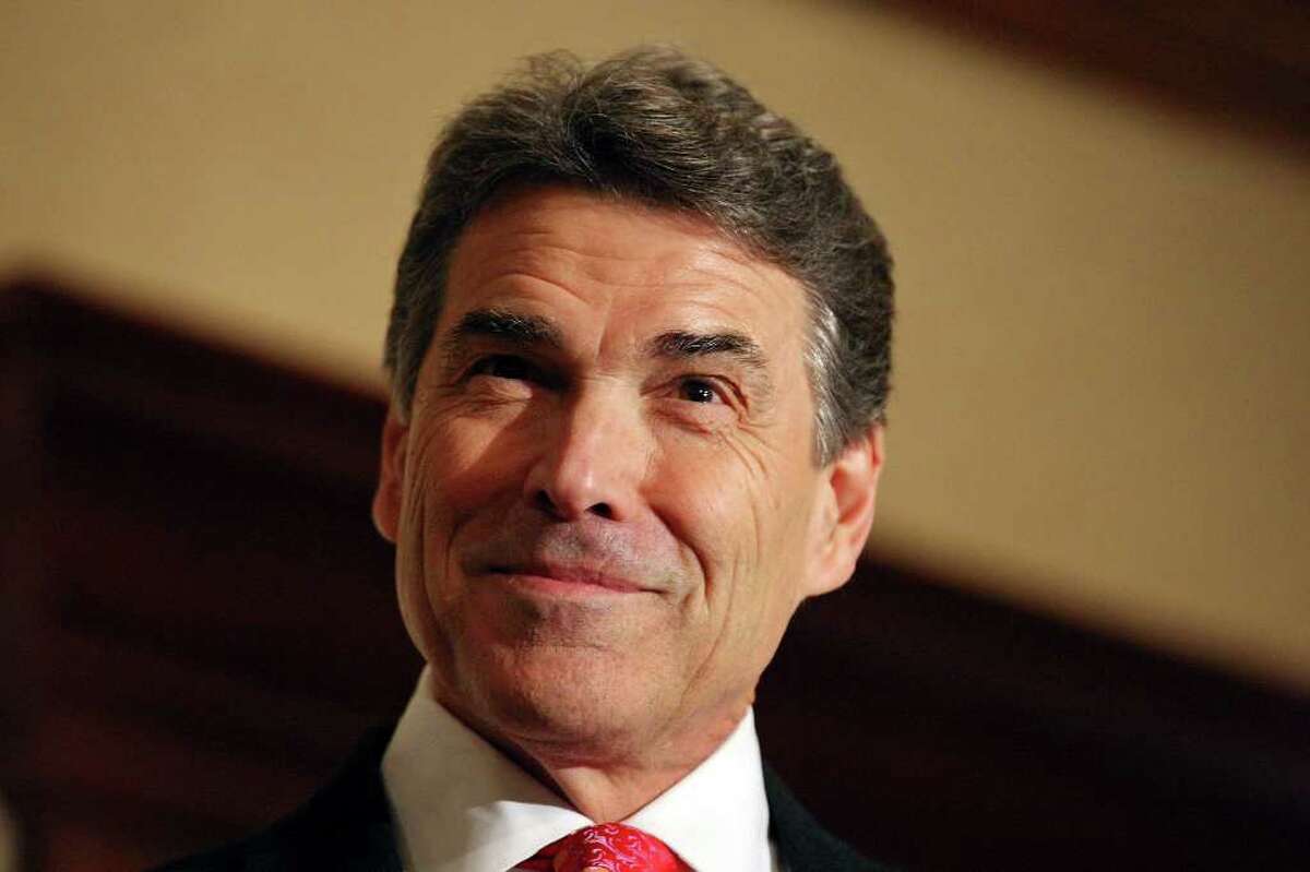 Perry says he's not done; slams Obama