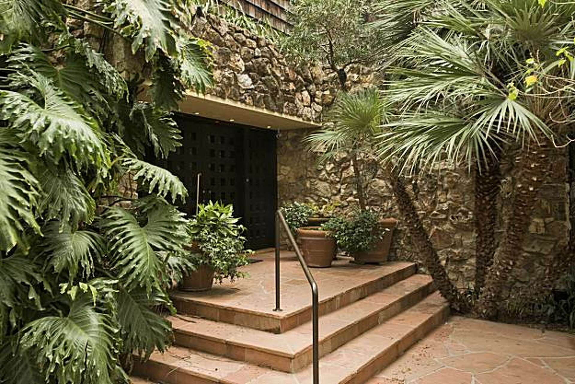 Tropical landscape, stone interior shelter Piedmont home