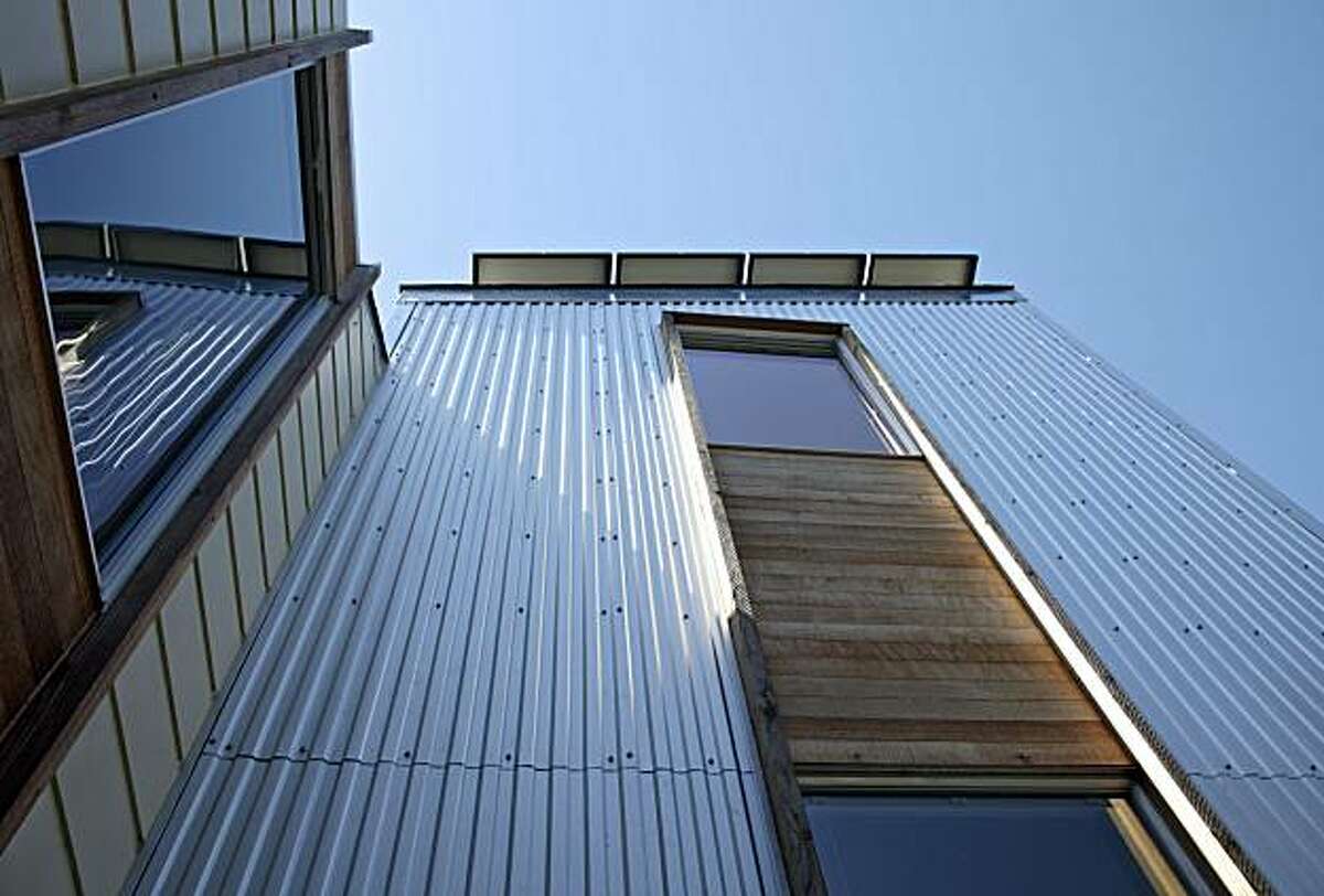 Simple wooden cottage adds a tower, gains space