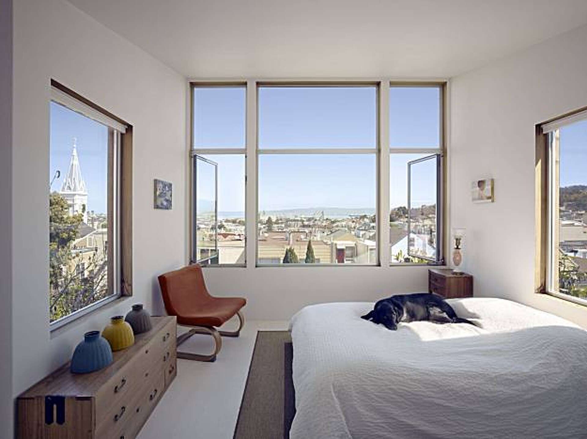 Simple wooden cottage adds a tower, gains space