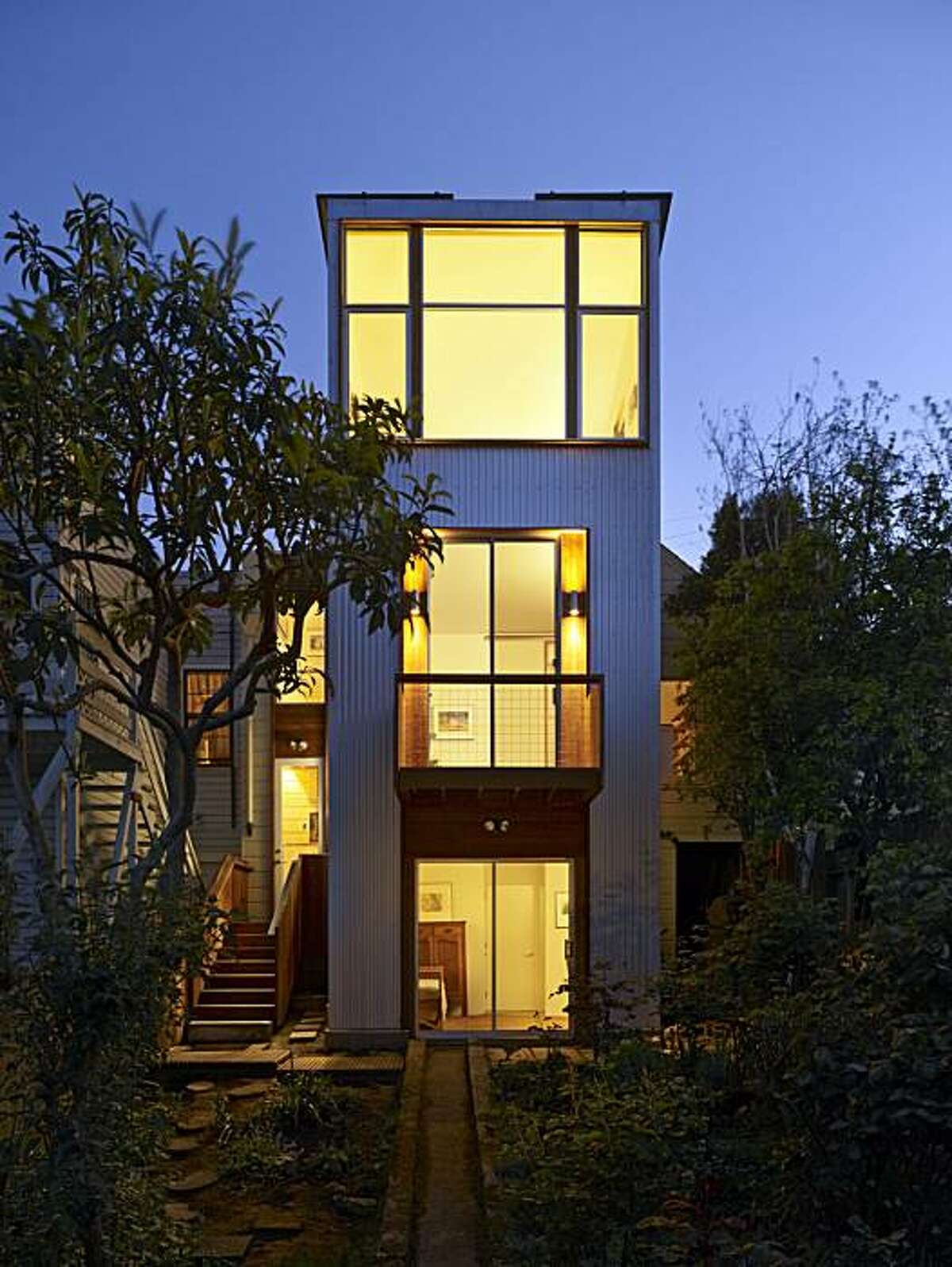 Simple wooden cottage adds a tower, gains space