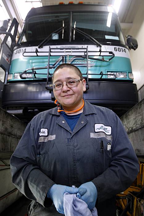 Accountant leaves desk to work under the hood