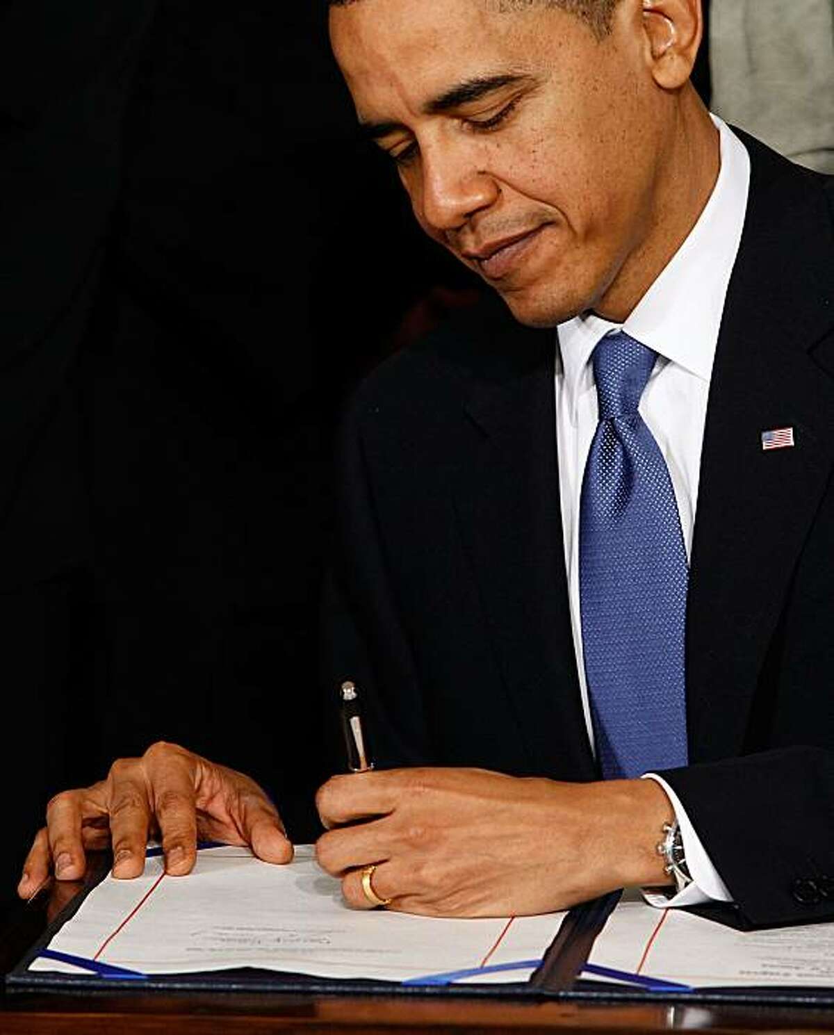 Obama signs health care reform into law