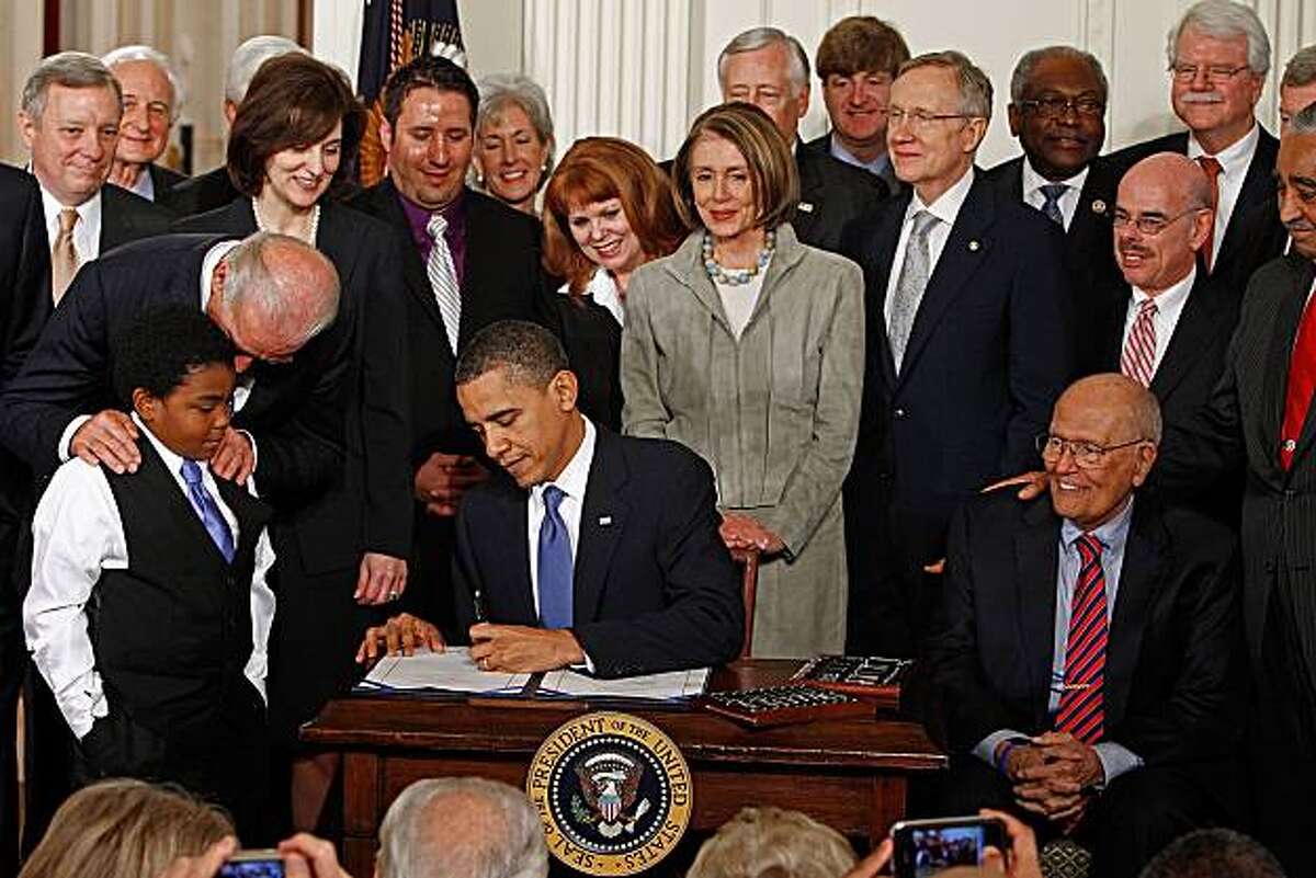 Obama signs health care reform into law