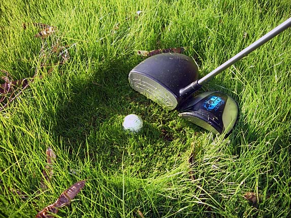 Big Daddy golf club drives and chops grass