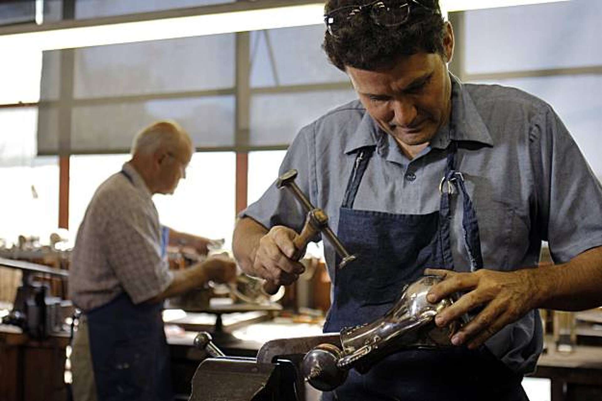 Old school silversmiths repair America's Cup