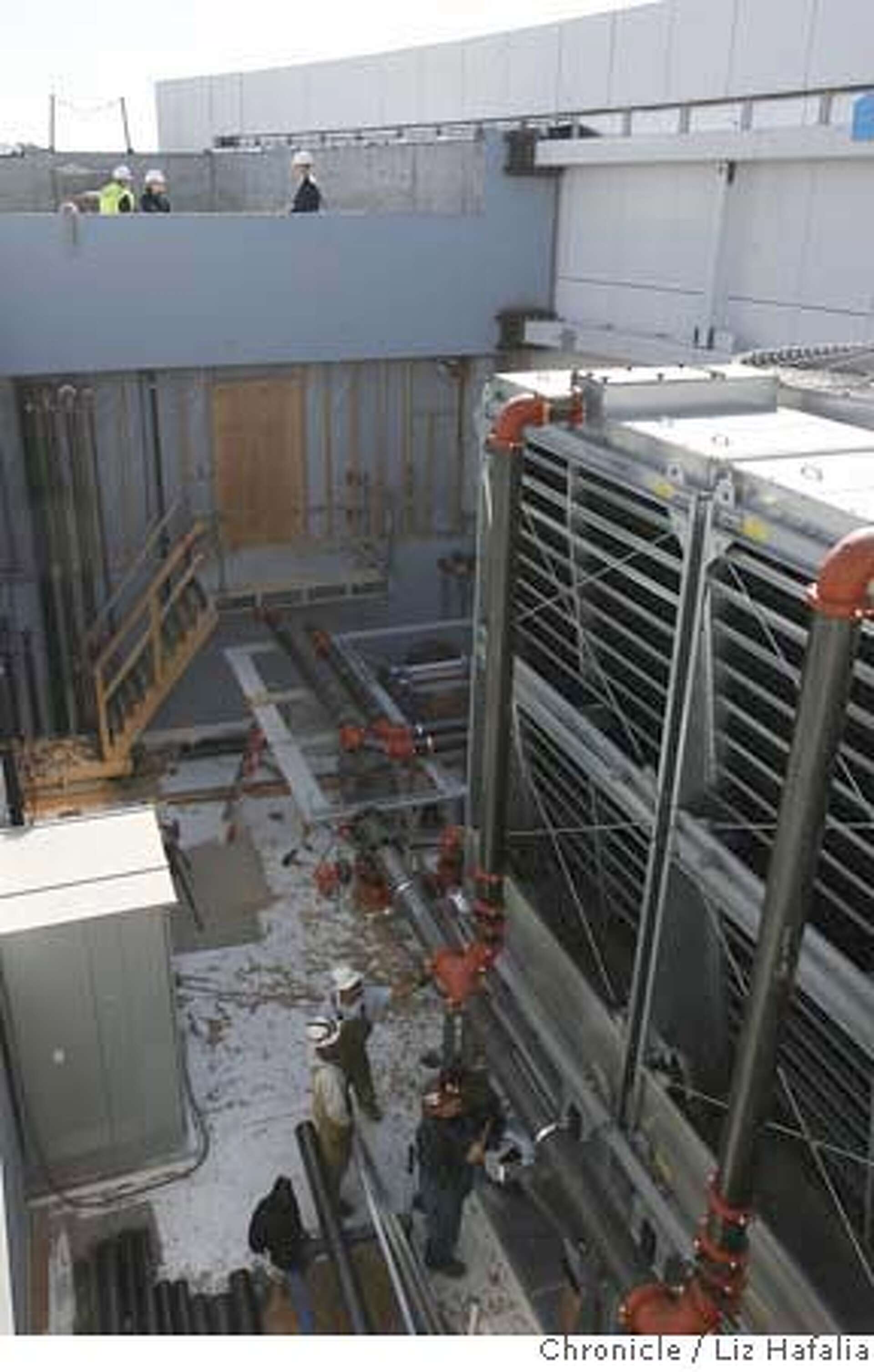 One Rincon tower features water tank on top to counteract wind