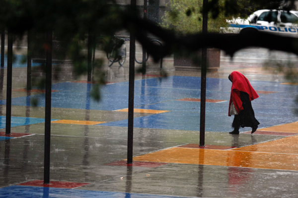 A homeless person enters the library. The librarian smiles.