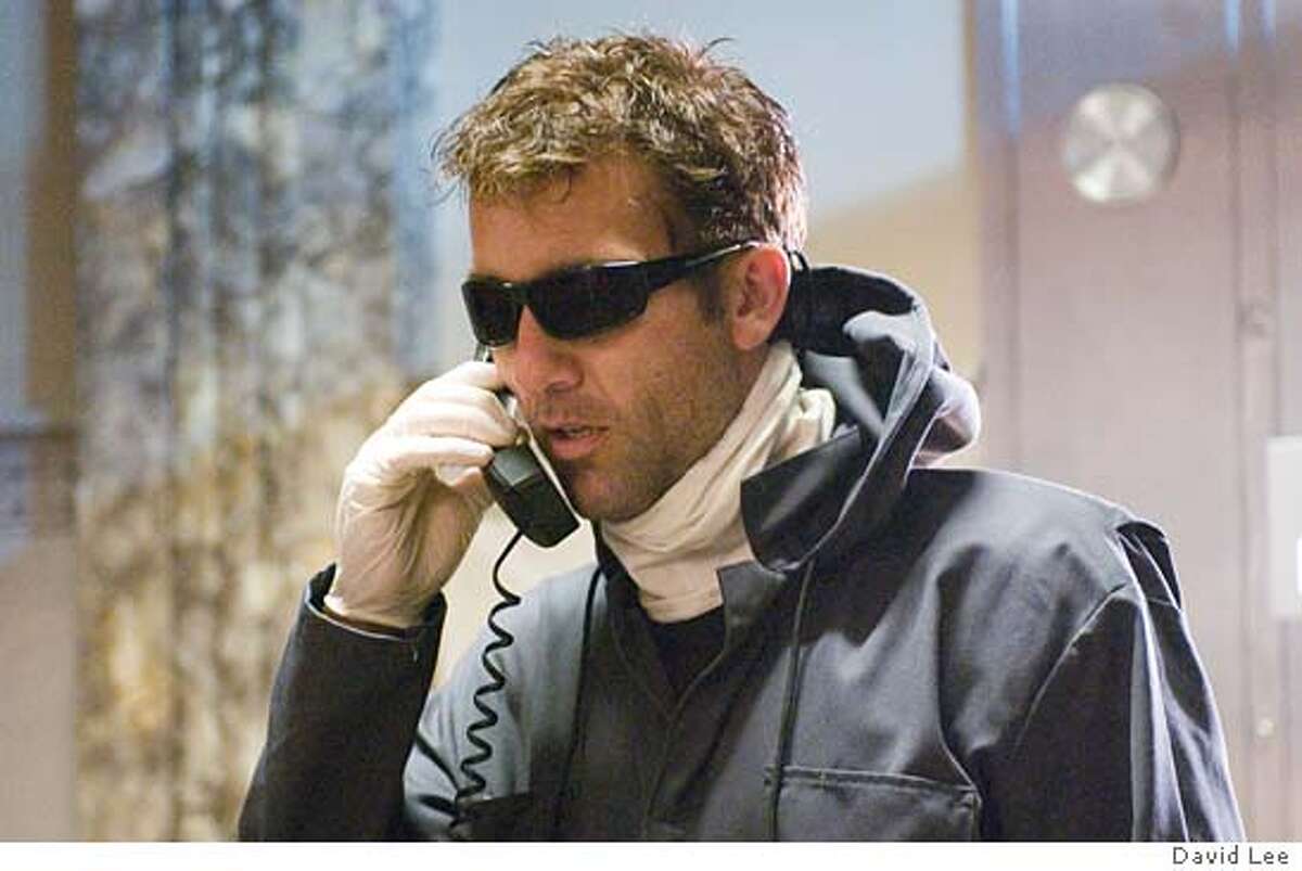 MOVIE REVIEWS / A masked man robs a bank. There's something inside he ...