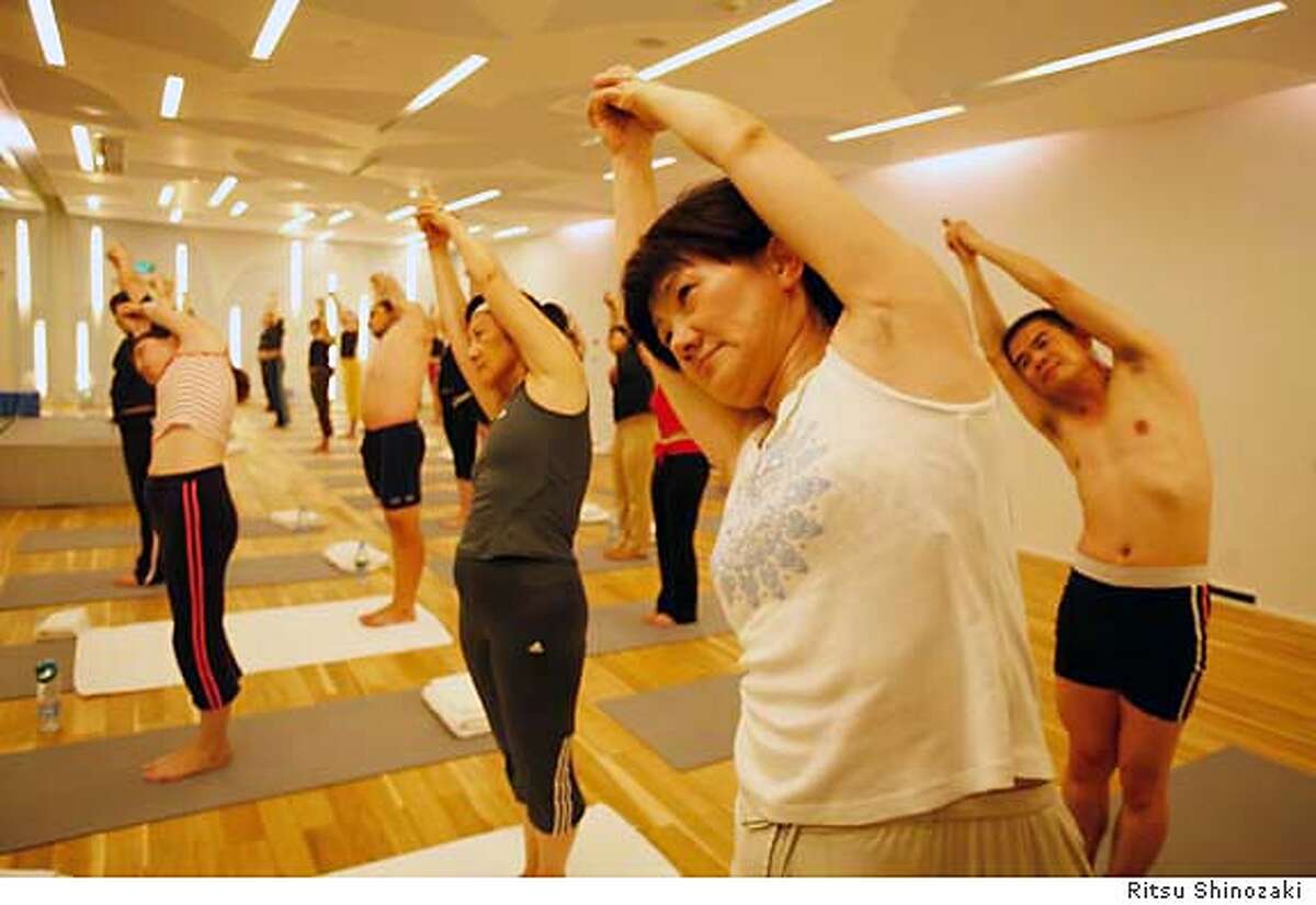 STRETCHING OUT / Chinese go wild over yoga centers