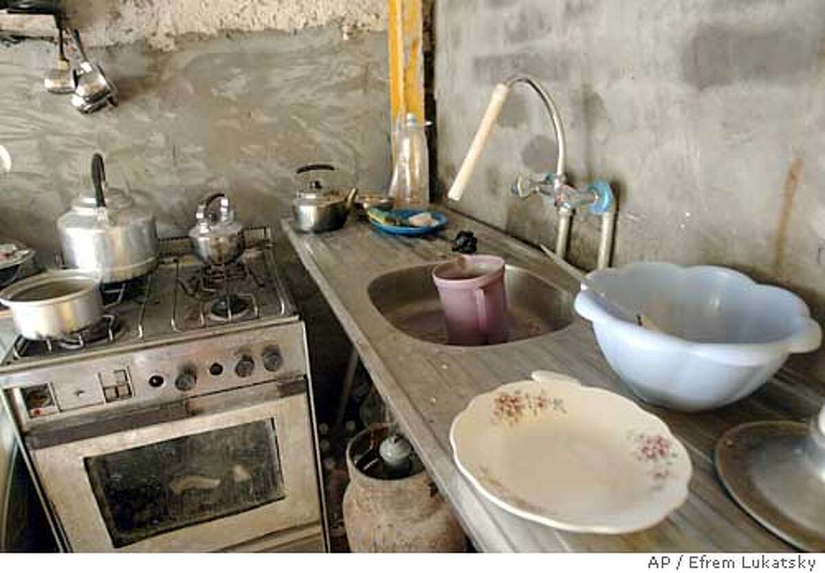 Hussein's hideaway a squalid shambles / Hut, litter belie former leader ...