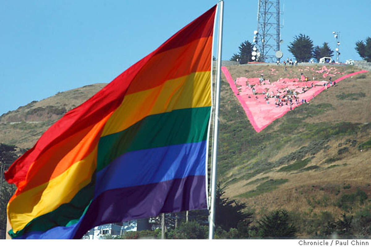 Volunteers construct pink triangle for Gay Pride weekend