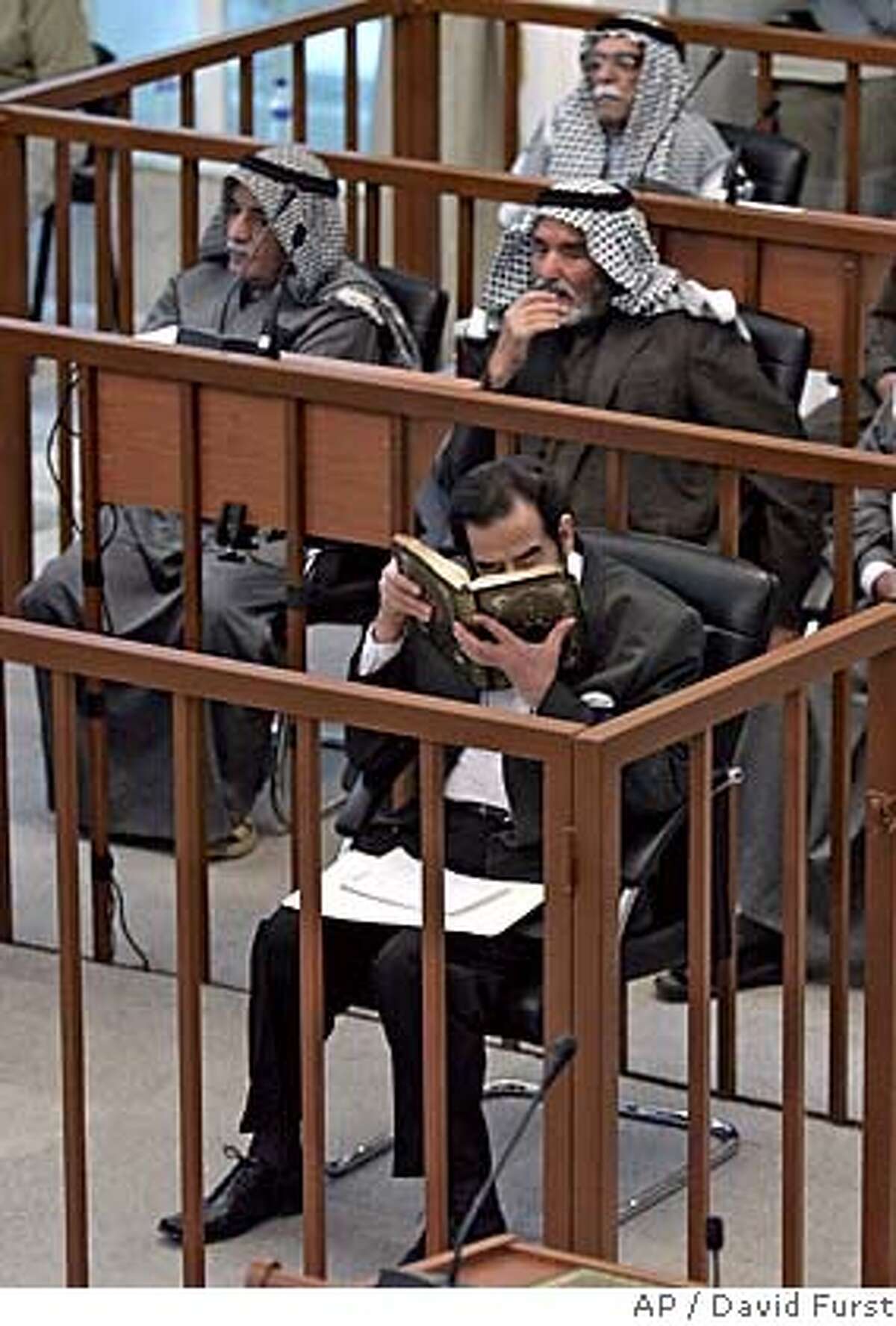 Hussein turns performance artist at trial / President turned defendant ...