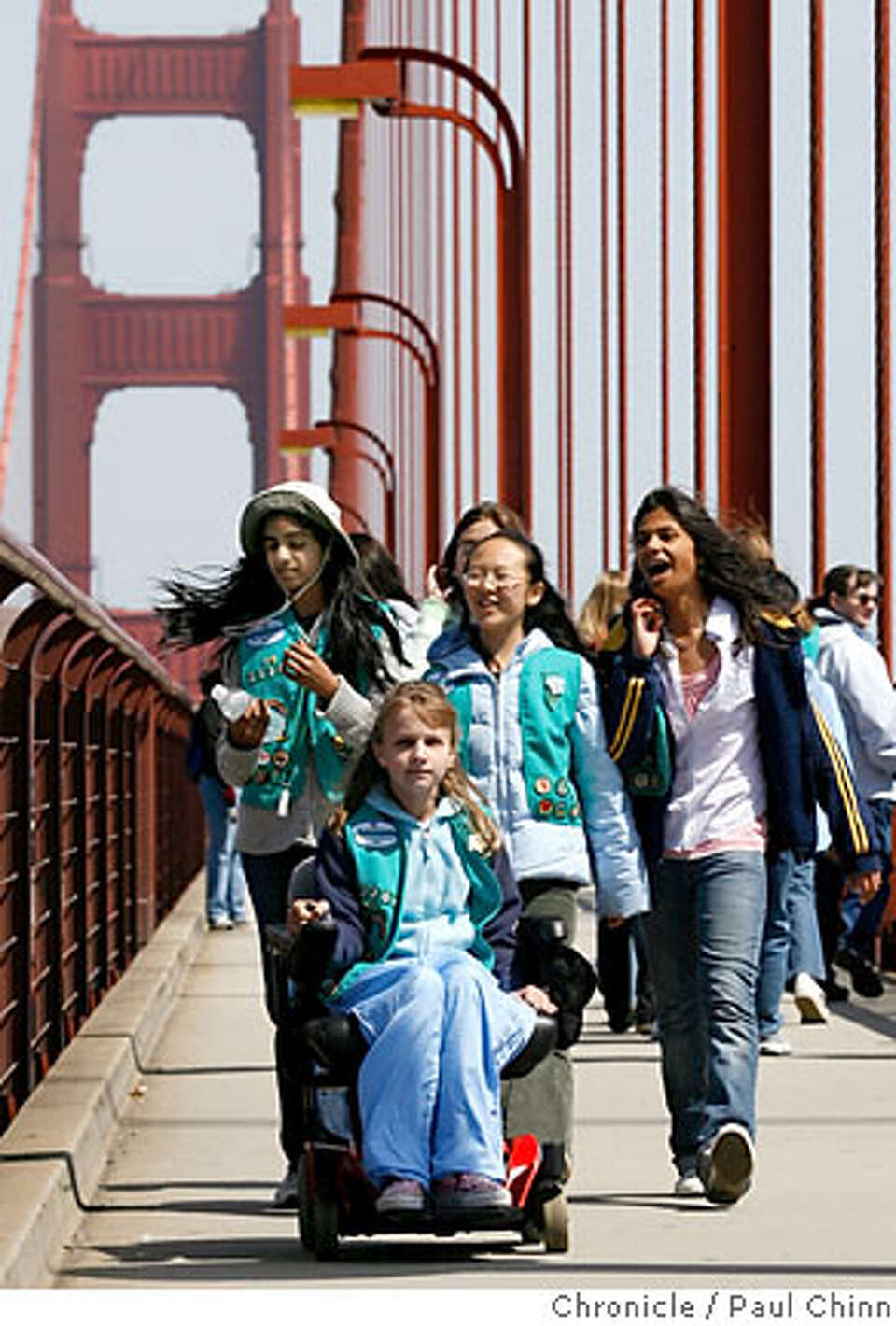 Girl Scouts cross a bridge