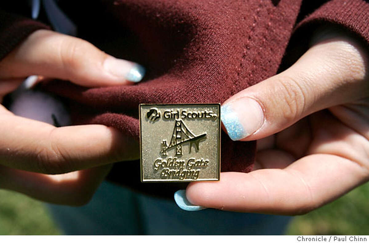 Girl Scouts cross a bridge