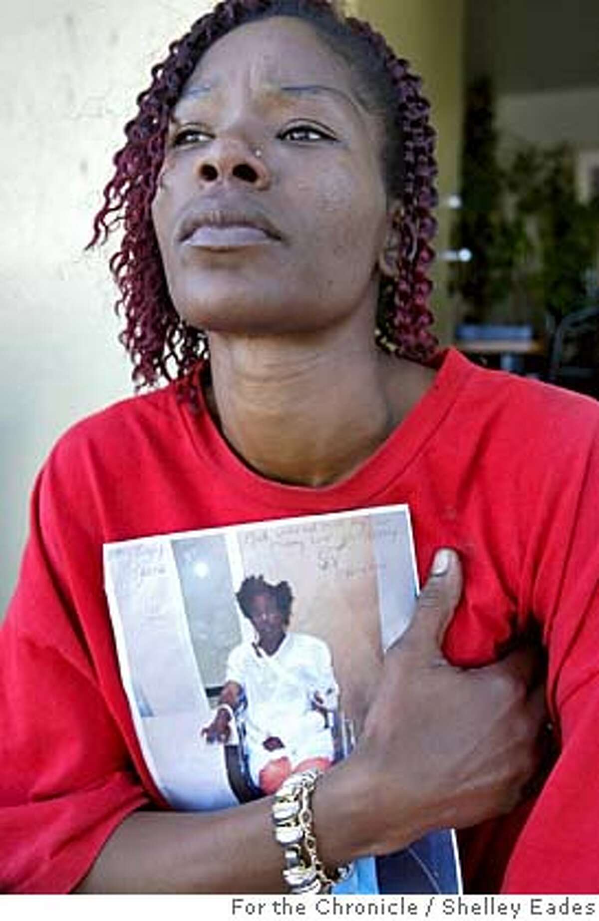 Police shooting raises distrust in Hunters Point / Tami Butler holds a ...