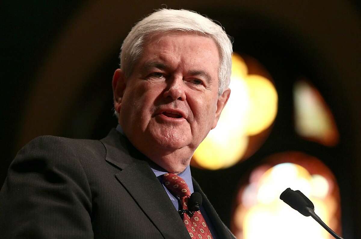 Gingrich slashes staff, pledges to fight on