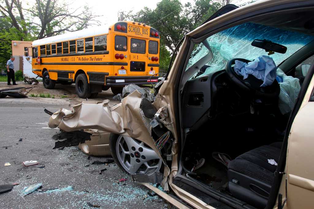Two hurt when school bus, car collide on South Side