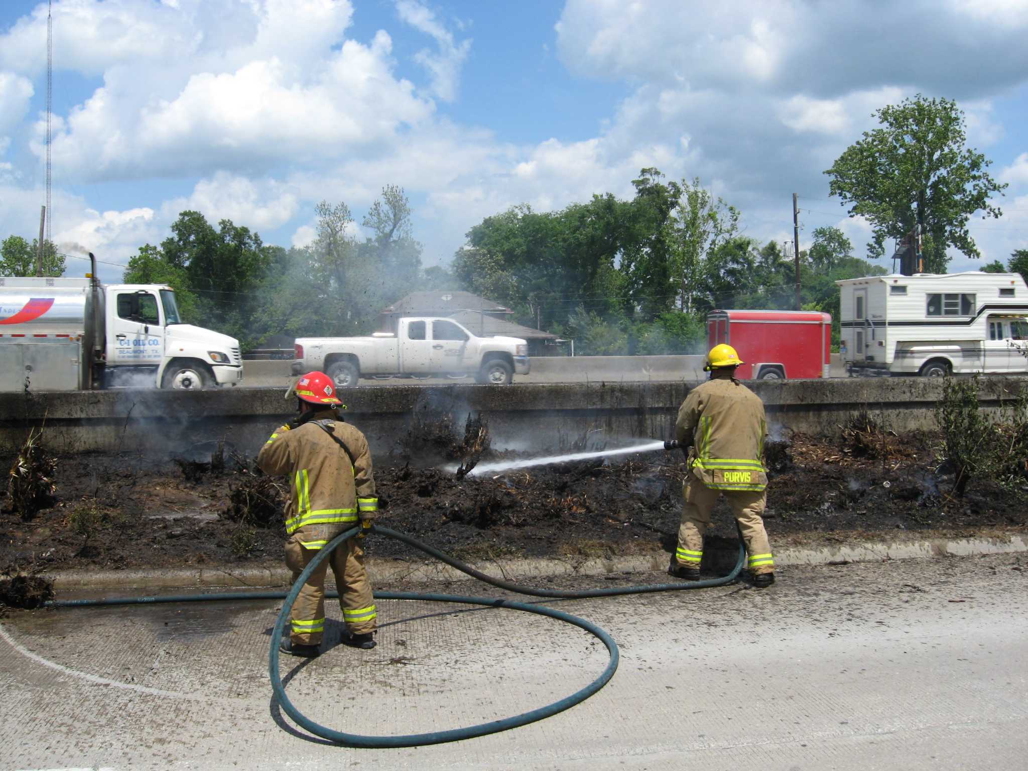 Highway embankment fire burns tire