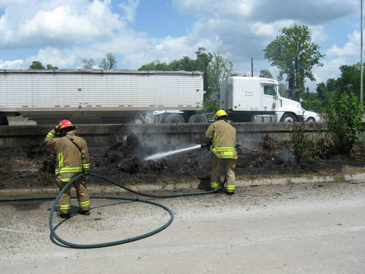 Highway embankment fire burns tire