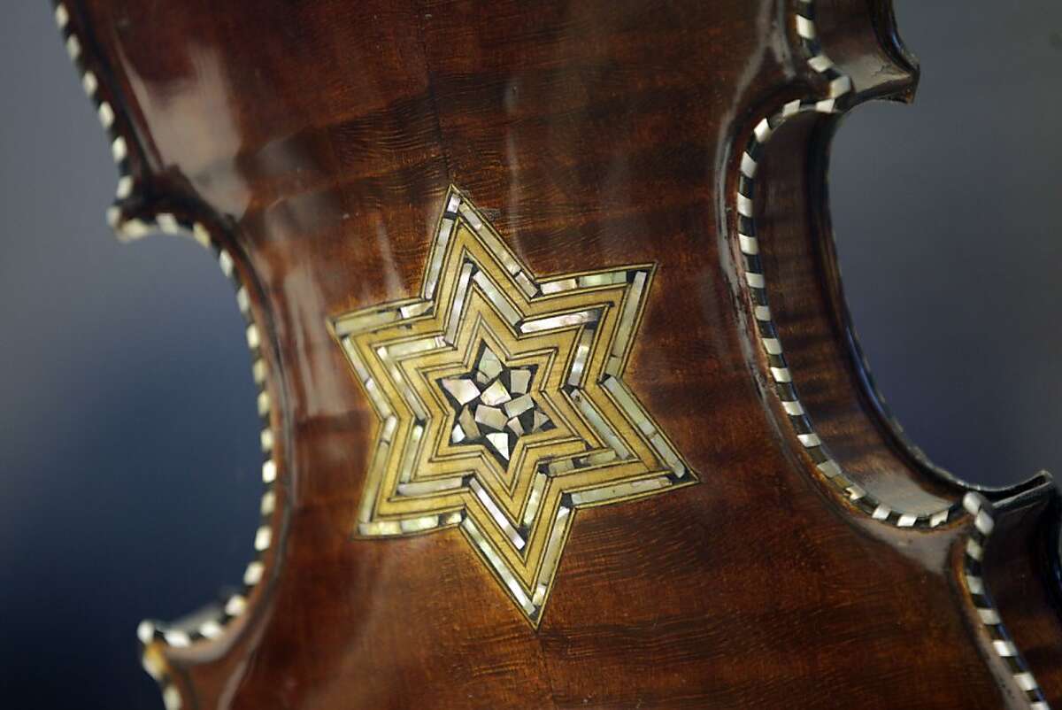 Restored violins bear sound, remembrance of Holocaust