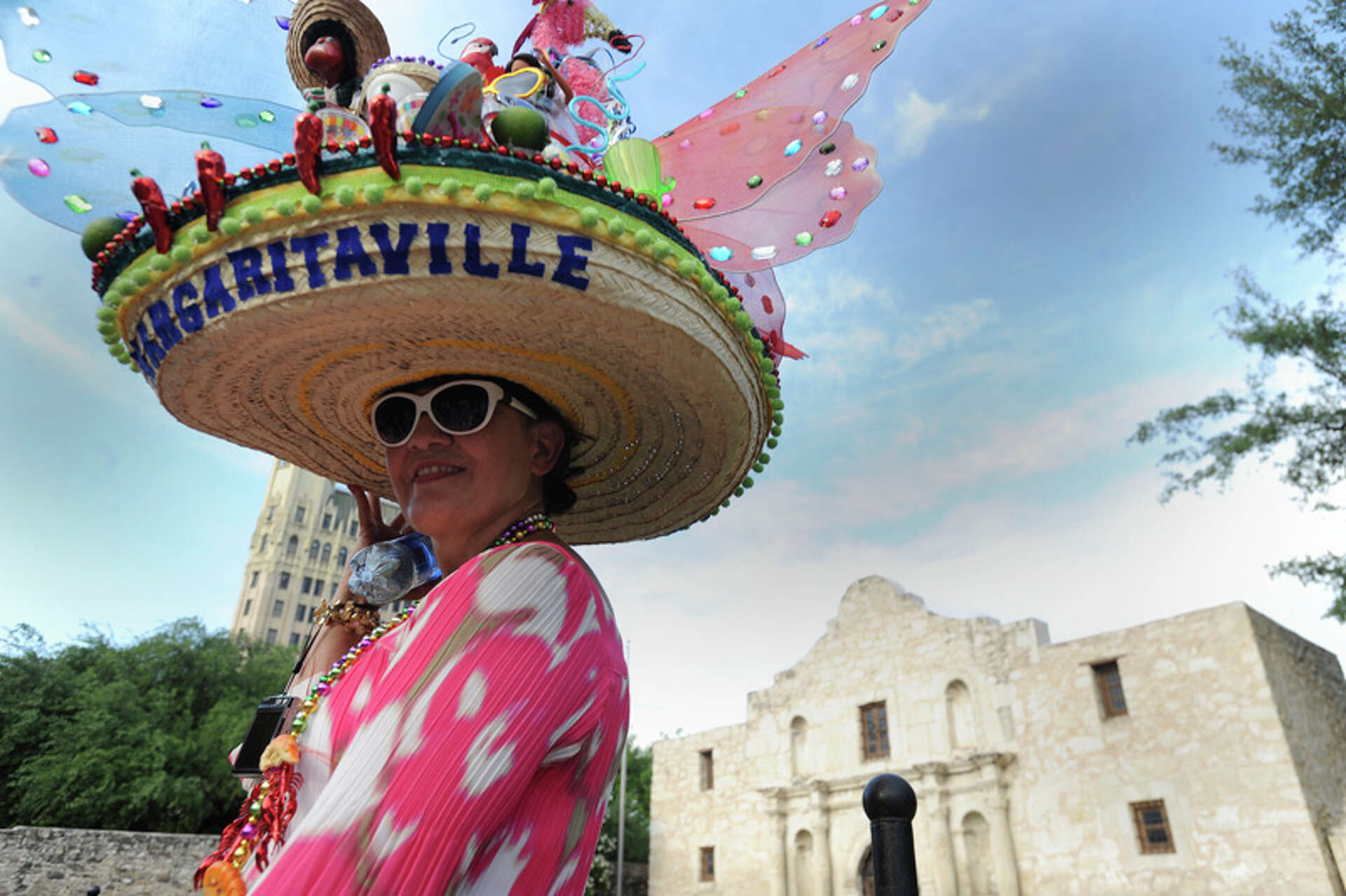 Towering hats, pins on parade mark Fiesta's kickoff