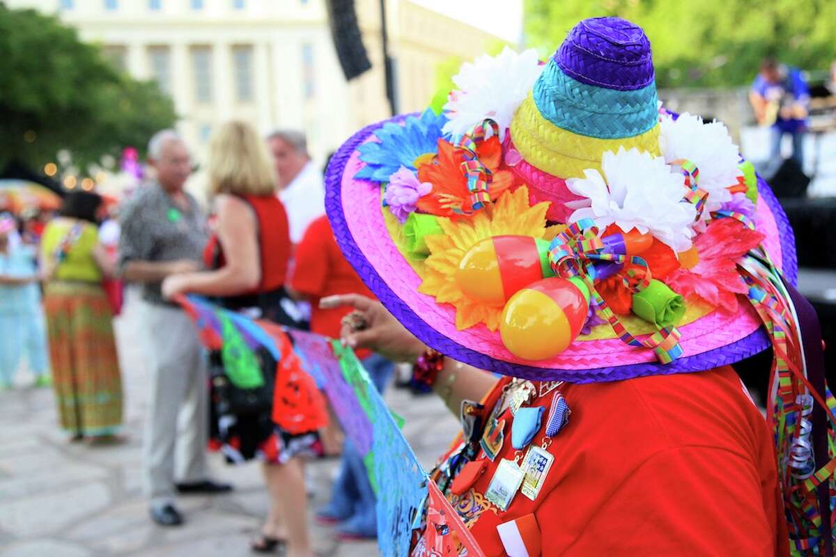 Towering hats, pins on parade mark Fiesta's kickoff
