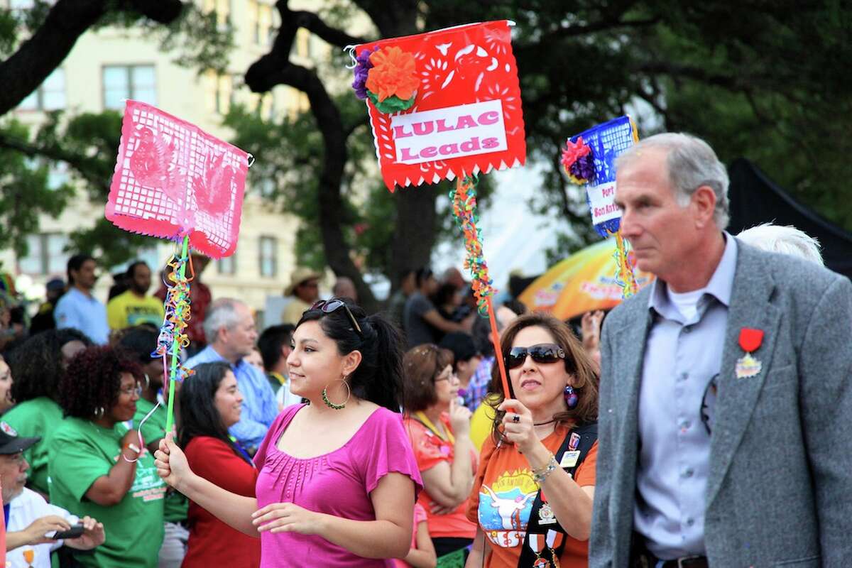 Towering hats, pins on parade mark Fiesta's kickoff