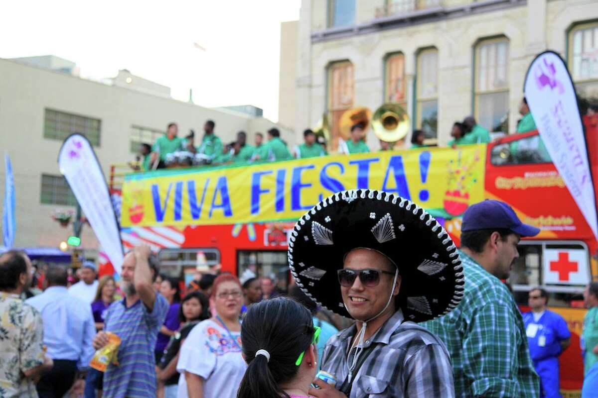 Towering hats, pins on parade mark Fiesta's kickoff