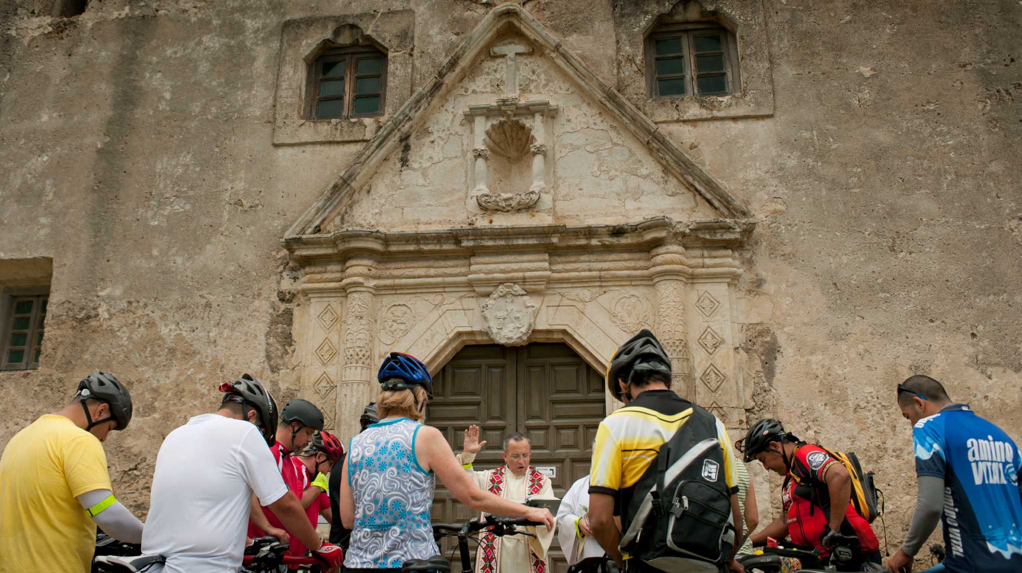 Praying for safe rides at blessing for bicyclists