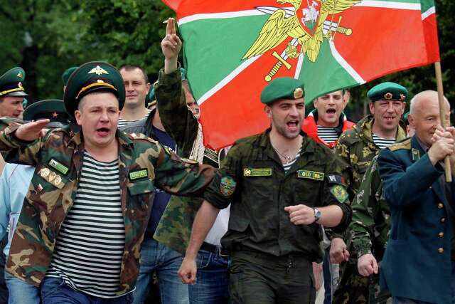 World news in pictures: Russian border guards day, fire in Qatar