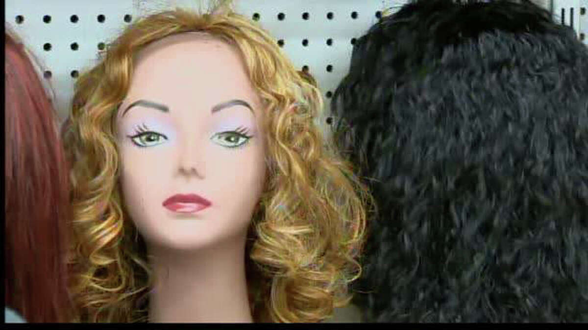 Cops: 'Crazed' woman stole wig, bit shop owner