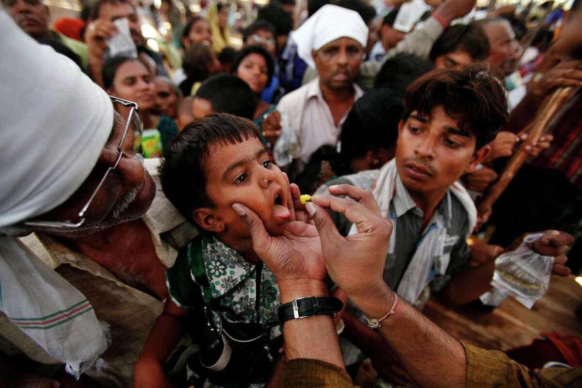 Indian believers swallow live fish as asthma cure