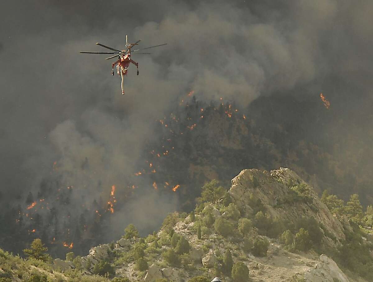 Colorado Springs crews fight wildfire near homes