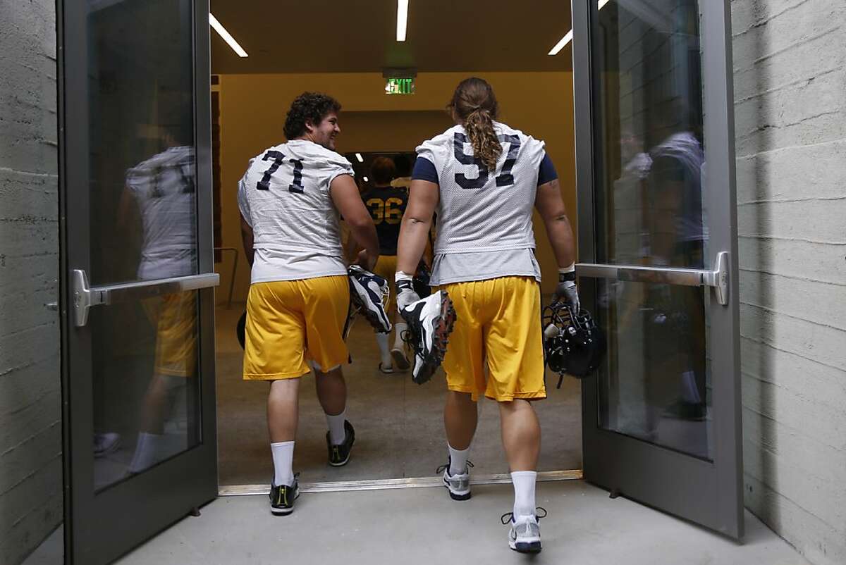 Cal football players give new turf a run